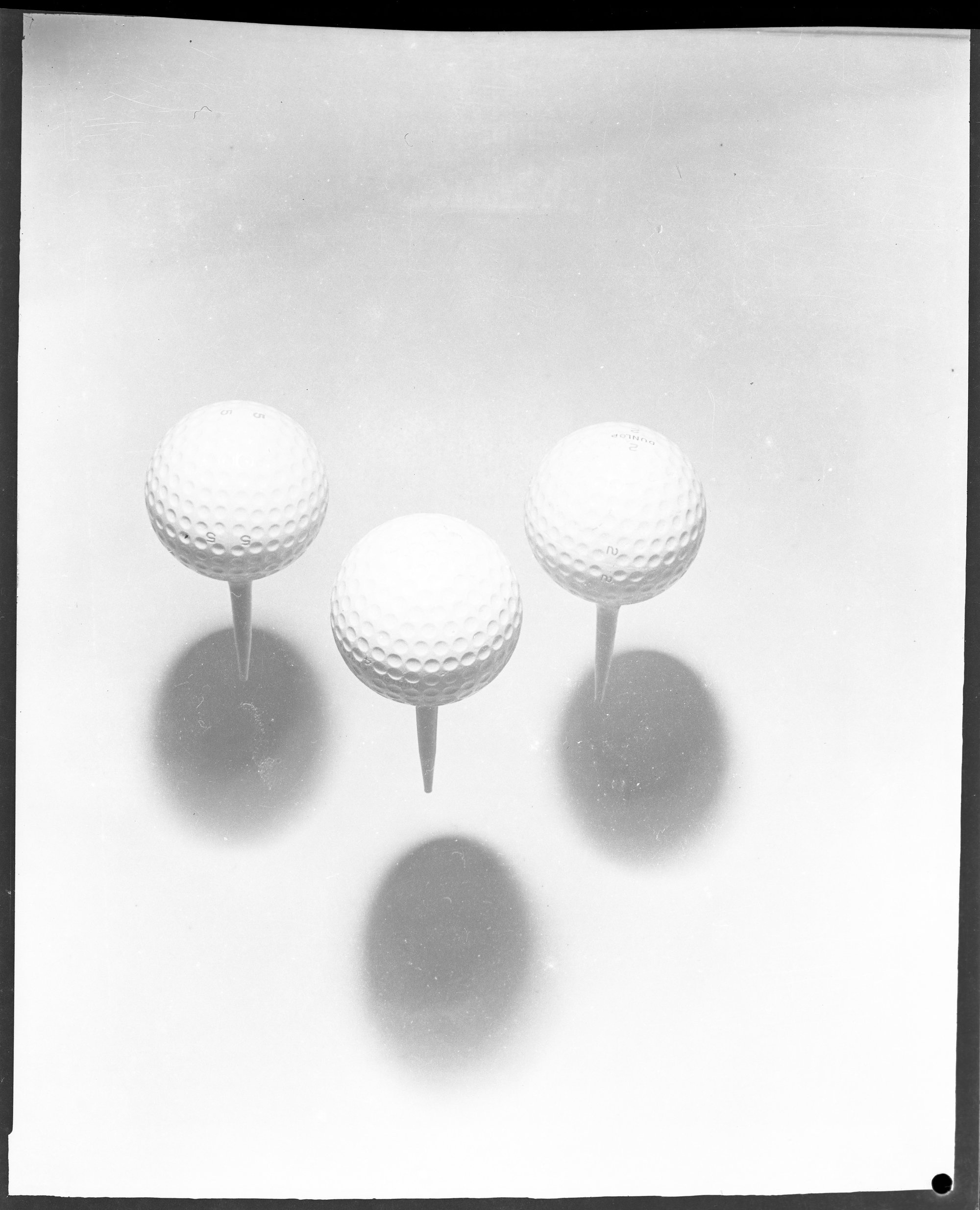 All teed up - three golf balls with shadow patterns | Living Histories