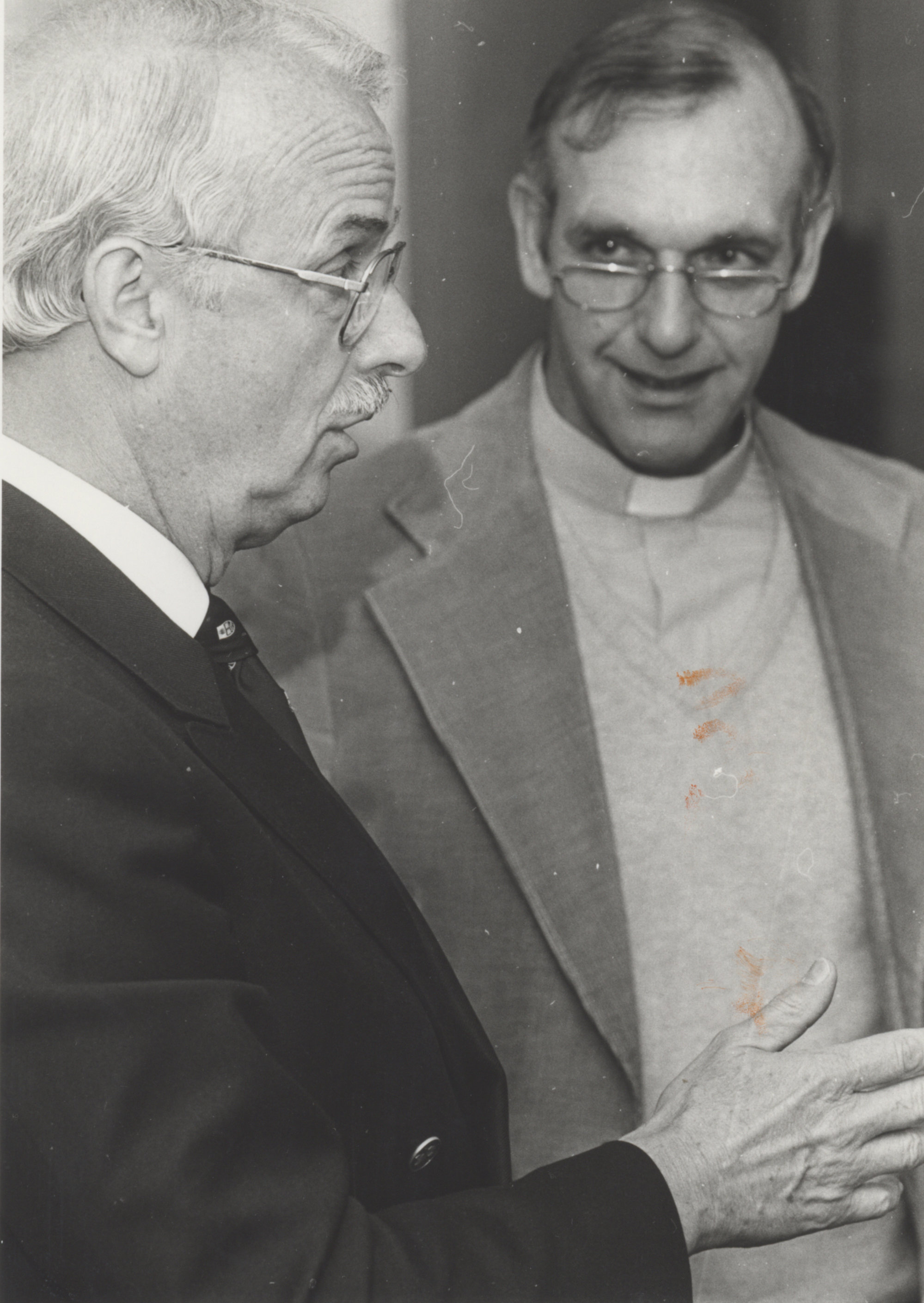 An unidentified man with Father James Bromley (r), the University of ...