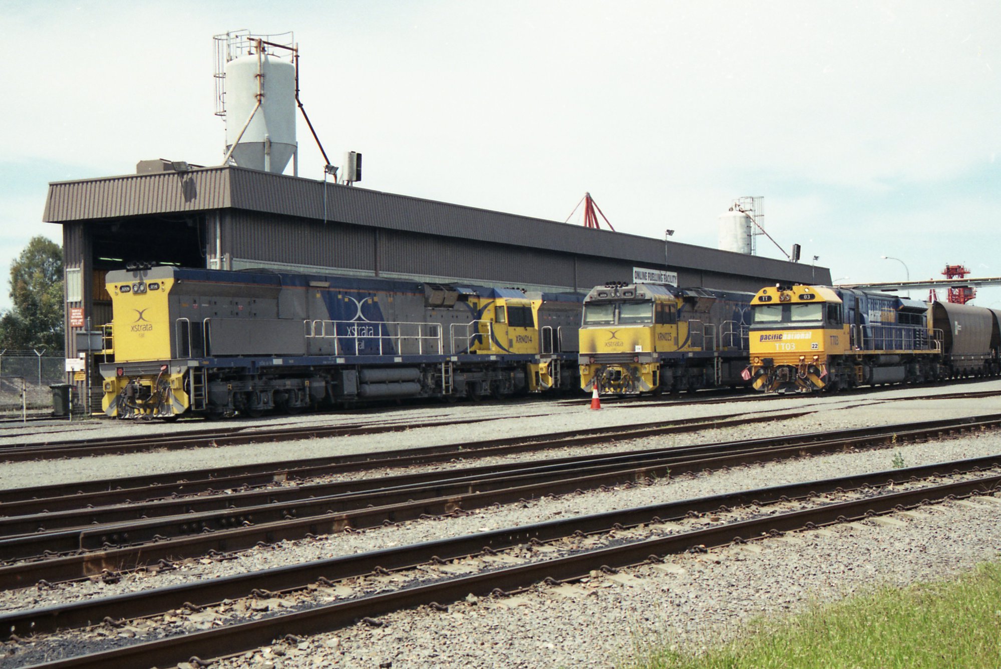 Xtrata locomotives and a Pacific National TT class locomotive stand on ...