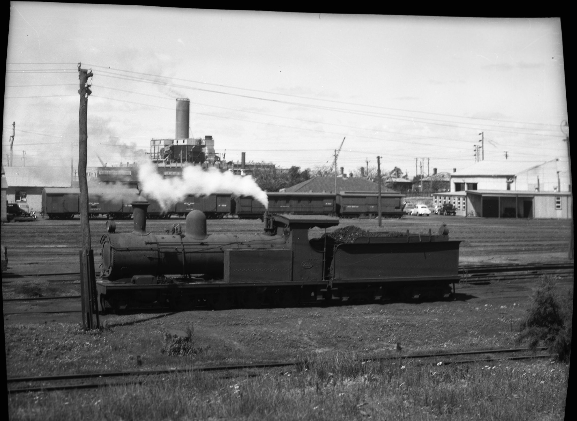 WAGR O Class, no. 215, in railway yard, goods vans and passenger ...